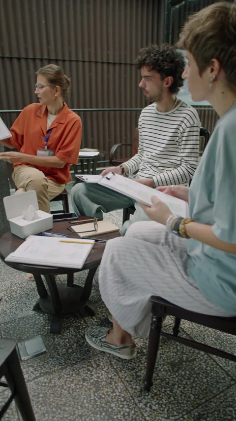 Therapist Giving Questionnaires to Group... | Stock Video | Pond5