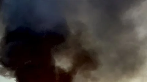 Thick black smoke wafts away in the wind... | Stock Video | Pond5