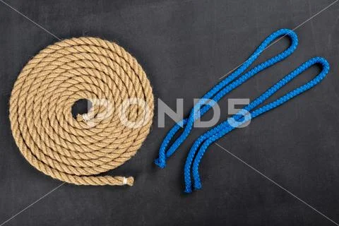 Thick jute rope coiled into a circle and short lines for tying the ...