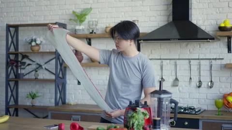 Thoughtful Asian man entering kitchen ho... | Stock Video | Pond5