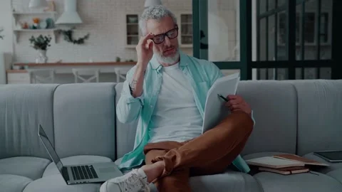 Senior Sitting Pappers Stock Videos – Royalty-Free HD & 4K Videos