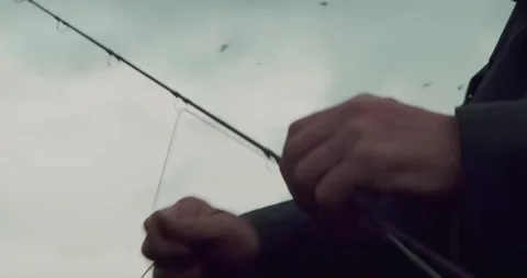 Threading fishing rod with line and bird... | Stock Video | Pond5