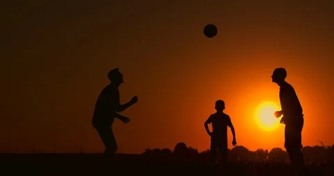 Three boys playing soccer at sunset. Sil... | Stock Video | Pond5