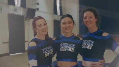 Three cheerleaders posing for a photo | Stock Video | Pond5