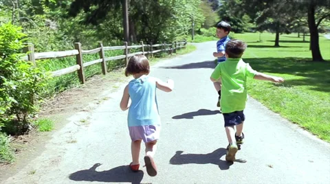 Three Children Run Freely Down Park Path... | Stock Video | Pond5