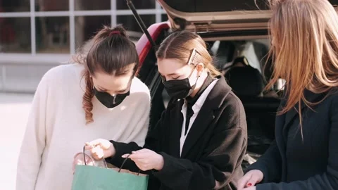 Three girls in masks are looking at shop... | Stock Video | Pond5
