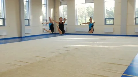 Three gymnast girls show an exercise in ... | Stock Video | Pond5