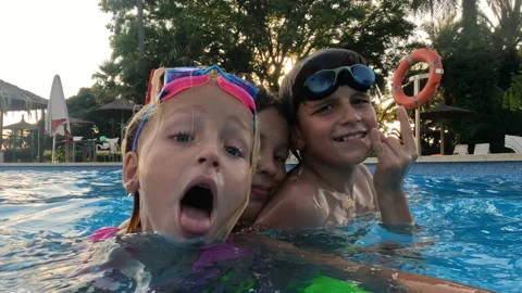 Three kids playing in the pool | Stock Video | Pond5