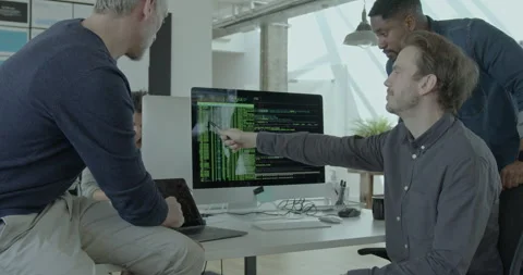 Three Male Engineers looking at Code on ... | Stock Video | Pond5
