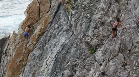 Three men climbing the rocky walls befor... | Stock Video | Pond5