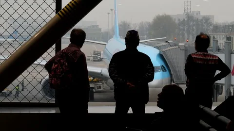 Three men stand against window, look out... | Stock Video | Pond5