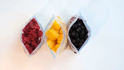Three packages with frozen fruits on whi... | Stock Video | Pond5