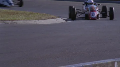Three race cars take a sharp corner on a... | Stock Video | Pond5