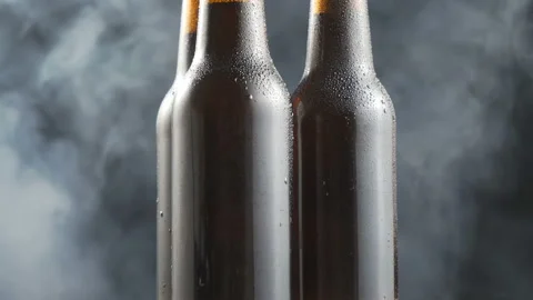 Three very cold beer bottles rotating on... | Stock Video | Pond5