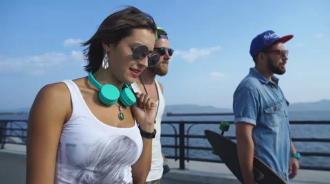 three young friends with skateboards tal... | Stock Video | Pond5