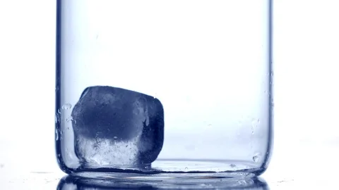 Throw ice cubes in empty glass | Stock Video | Pond5
