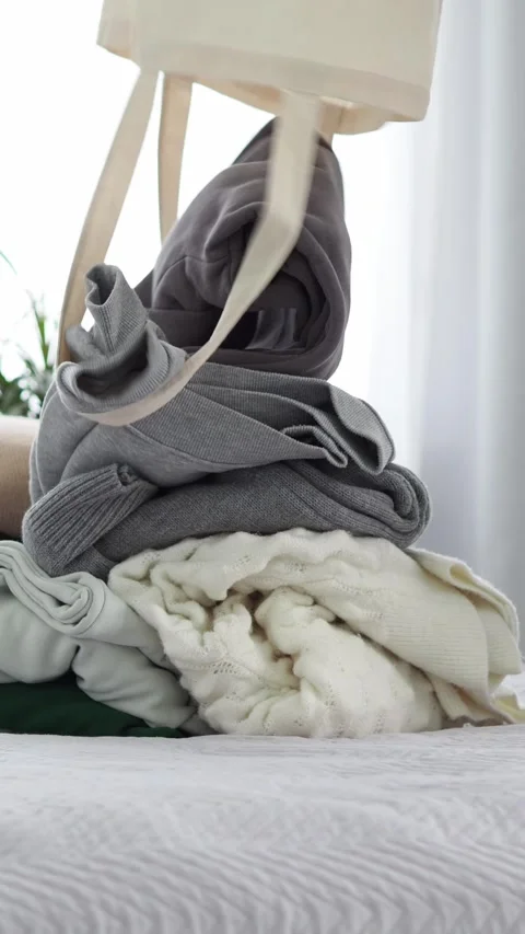 Throw old clothes out of a textile bag w... | Stock Video | Pond5