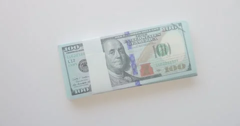 Throw a pile of 100 dollar bills on a wh... | Stock Video | Pond5