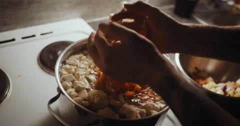 Throwing fresh chopped vegetables to pot... | Stock Video | Pond5