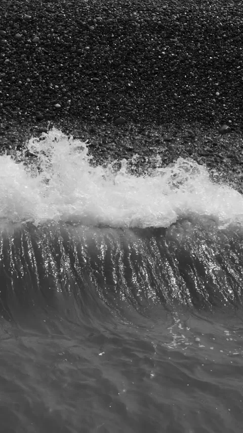 tidal bore. A wave rolls on a rocky beac... | Stock Video | Pond5