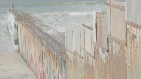 Tijuana beach border line with sea crash... | Stock Video | Pond5