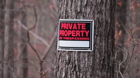 tilt up to no trespassing sign on tree | Stock Video | Pond5