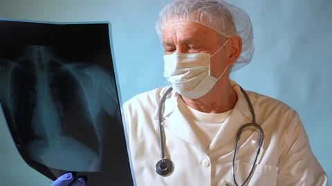 Tilt of senior doctor checking chest x-r... | Stock Video | Pond5
