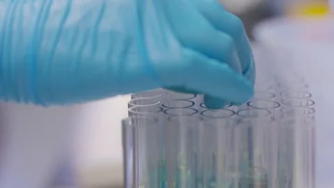Tilt shot of doctors examining test tube... | Stock Video | Pond5