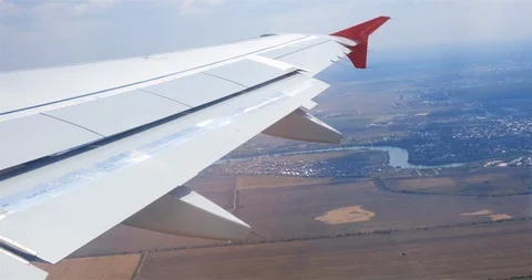 Tilt up of white airplane wing, up in th... | Stock Video | Pond5