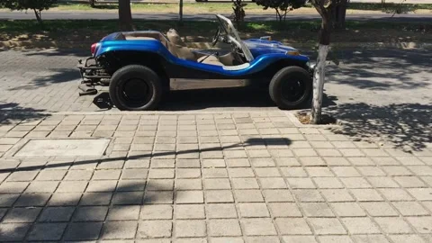 Tilting view, blue dune buggy parked on ... | Stock Video | Pond5