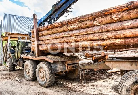 Timber carrier with sawn logs at the wood storage place ~ Hi Res #234190283