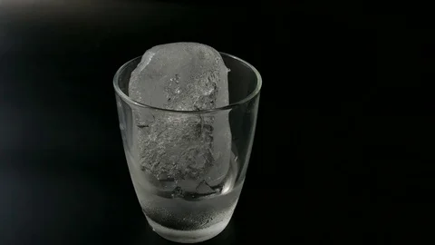 time laps Melting of ice in glass With a... | Stock Video | Pond5
