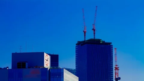 A time lapse of moving cranes on the top... | Stock Video | Pond5