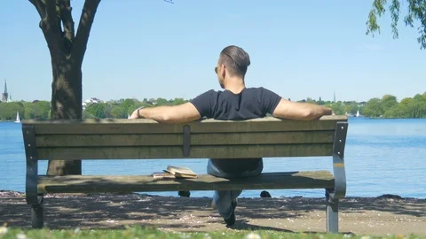 Time to slow down - chilling on a bench ... | Stock Video | Pond5