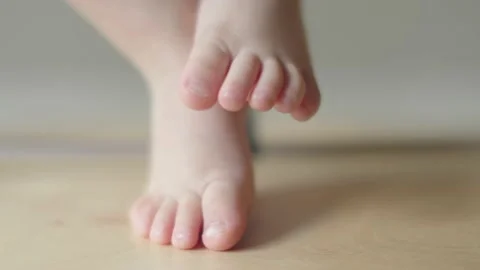 tiny barefoot baby feet of sitting child... | Stock Video | Pond5