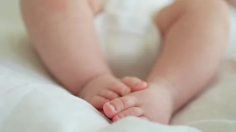 Tiny newborn infant baby feet and toes o... | Stock Video | Pond5