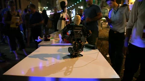 A tiny robot dances and stretches his mu... | Stock Video | Pond5