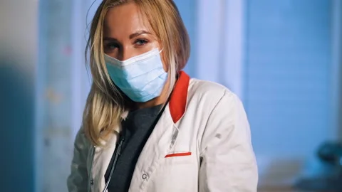 Tired female doctor in surgical mask loo... | Stock Video | Pond5