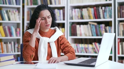 Tired female student suffering from head... | Stock Video | Pond5