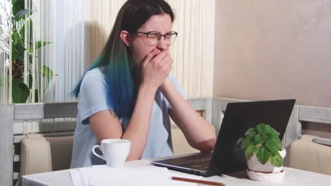 Tired girl student is typing on a laptop... | Stock Video | Pond5