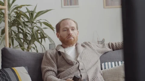 Tired Man Watching Movie on TV | Stock Video | Pond5