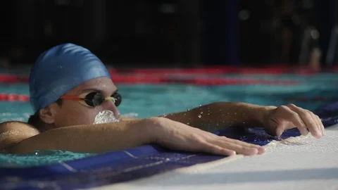 The tired swimmer rests in the pool | Stock Video | Pond5