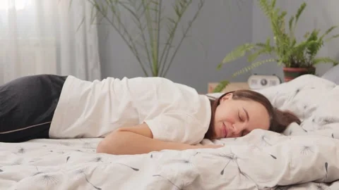 Tired woman falling down into bed with s... | Stock Video | Pond5