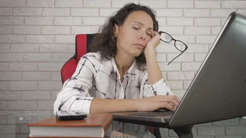 A tired woman falls asleep at the comput... | Stock Video | Pond5