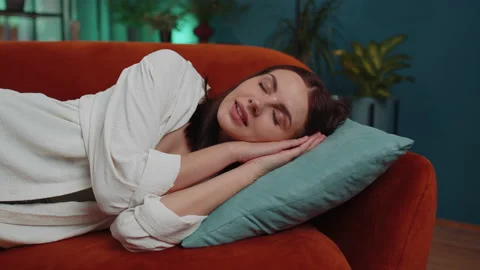 Tired young woman lying down in bed taki... | Stock Video | Pond5