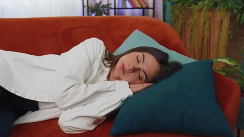 Tired young woman lying down in bed taki... | Stock Video | Pond5