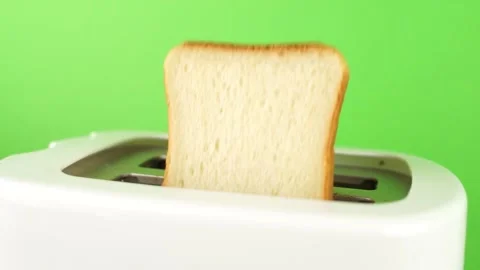 toast fried in a toaster on a green back... | Stock Video | Pond5