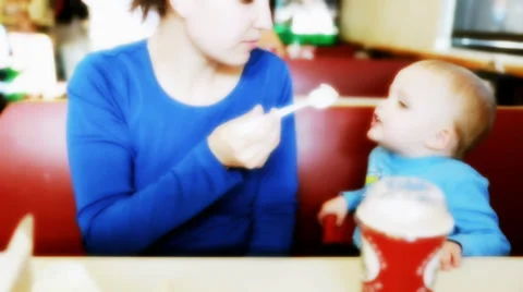toddler and his mother eating milk shake | Stock Video | Pond5