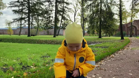 toddler child little boy in a yellow jac... | Stock Video | Pond5