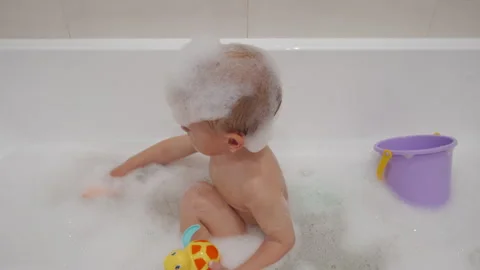 toddler child playing with bath toys tak... | Stock Video | Pond5